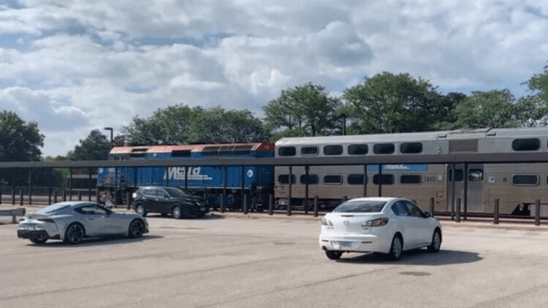 Two groups of migrants arrive via bus at Naperville Metra Station