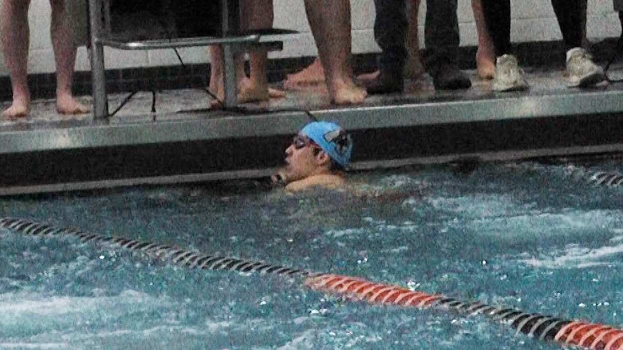 Robert Hargrove narrowly wins 100-yard butterfly for Naperville Central ...